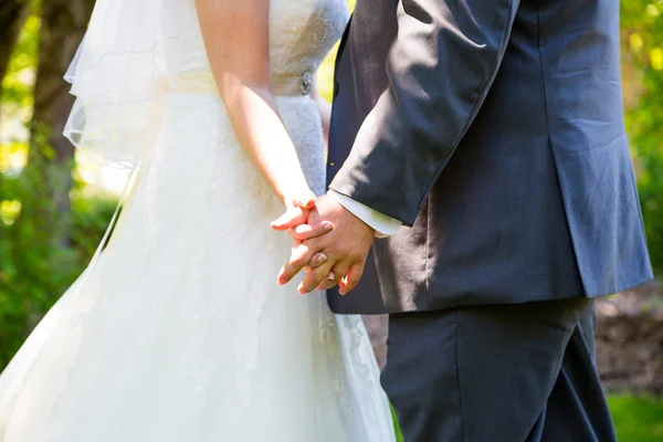 Wedding couple holding hands — Stock Photo © halfpoint #62786725