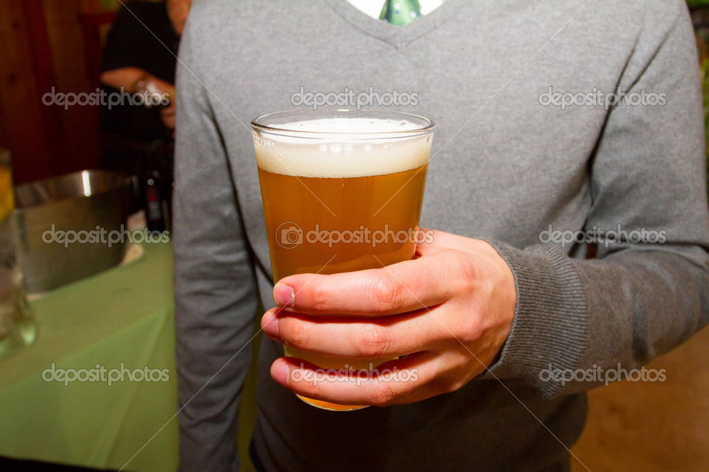 Hand Holding Beer in Glass Stock Photo by ©joshuarainey 46570525