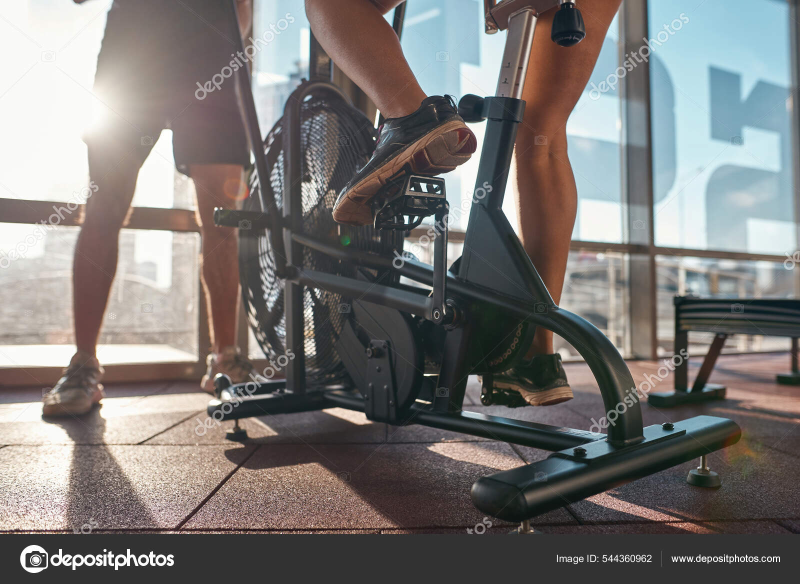 Woman do cardio exercise on orbitrek near trainer Stock Photo by ...