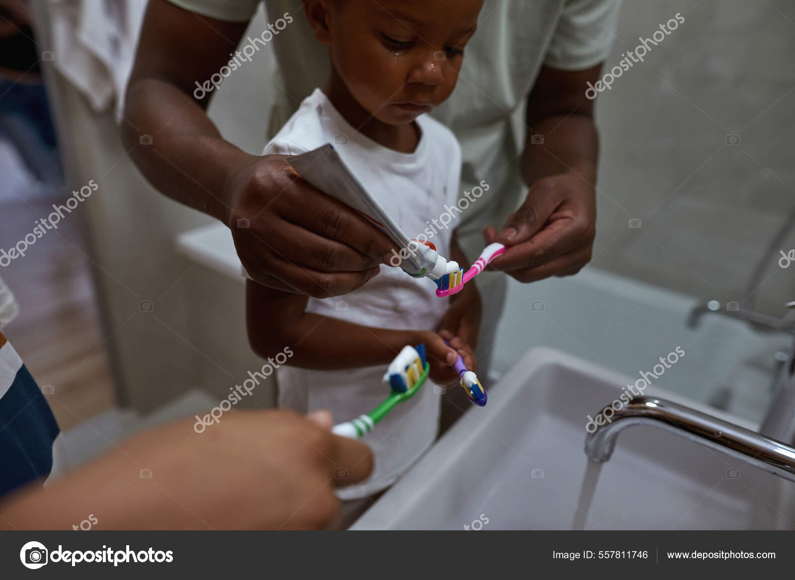 Cropped of father pouring toothpaste for his kids Stock Photo by ...
