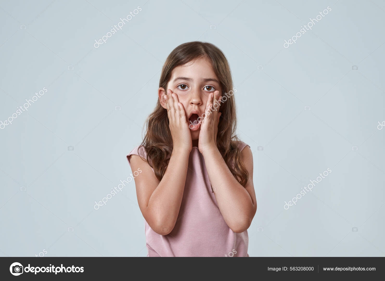 Front view of shocked little girl touch her face — Stock Photo ...