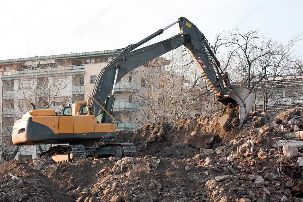 Demolition trucks in action. Demolition of an old block of flats ...