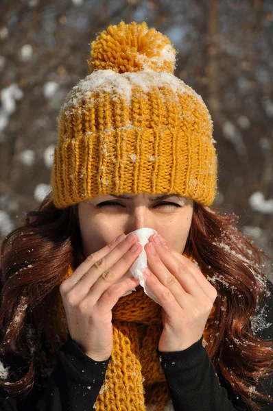 Woman sneezing into tissue, winter outdoor portrait - Stock Image ...