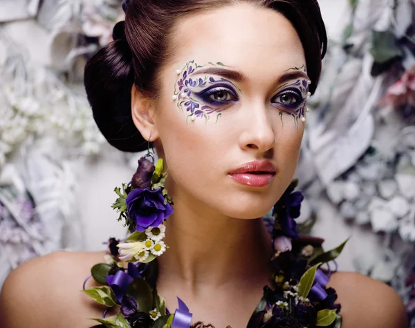 Floral face art with anemone in jewelry, sensual young brunette woman ...