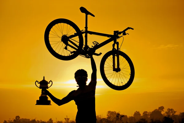 Cyclist raising his mountain bike — Stock Photo © weerapat #39731297