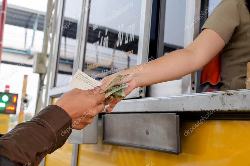 Man paying money at toll booth — Stock Photo © thekaikoroez #46008429