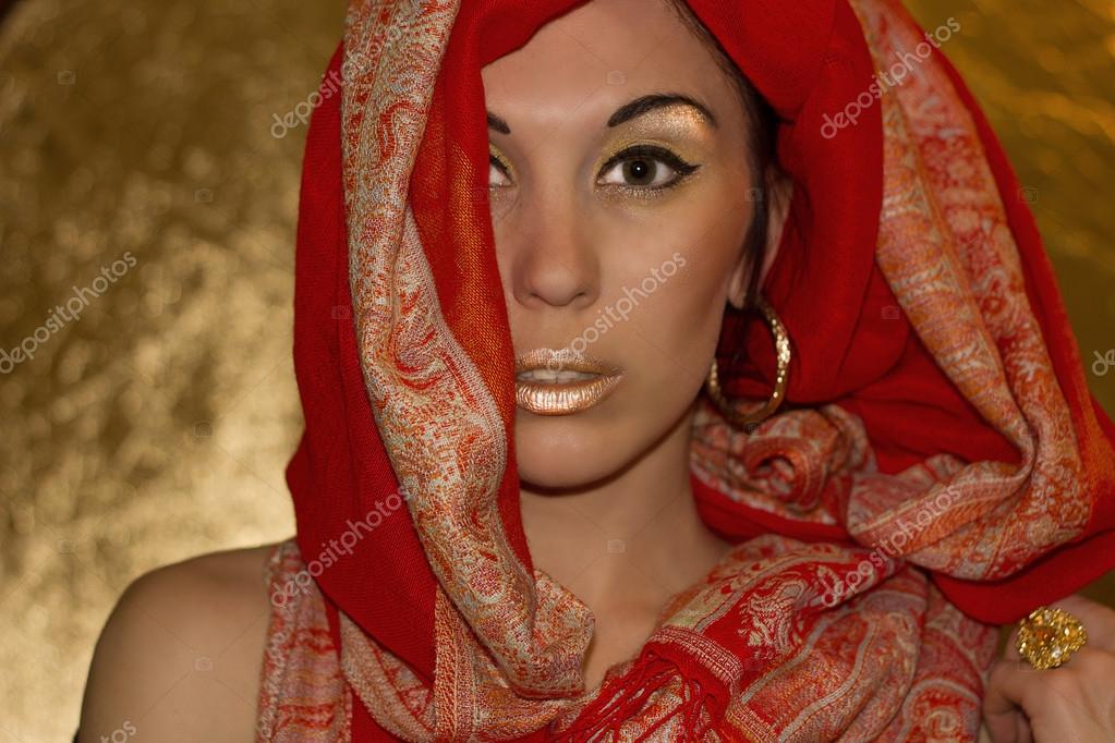 Arabic young woman. Gold makeup. Red clothes. Stock Photo by ...