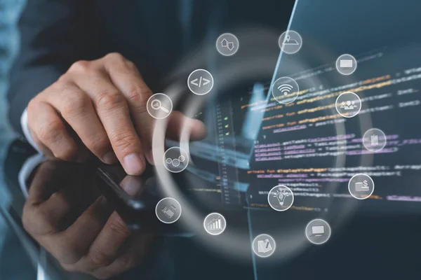 Software developer coding computer program with augmented reality dashboard, mobile app design ...