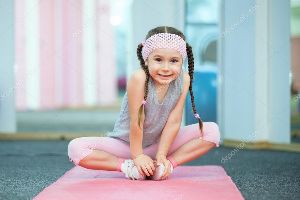 Kid doing fitness exercises Stock Photo by ©SvetaOrlova 38119047