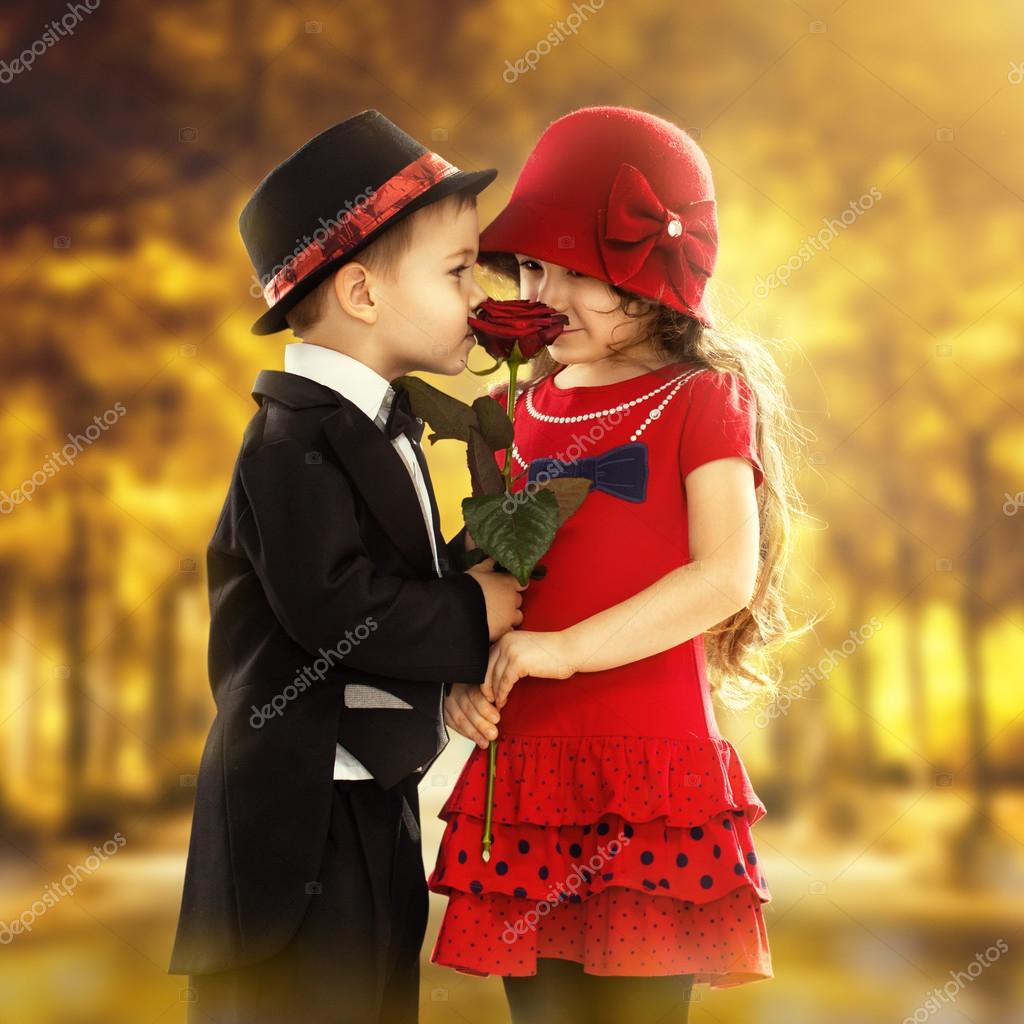 Lovely little boy giving a rose to girl — Stock Photo © SvetaOrlova ...