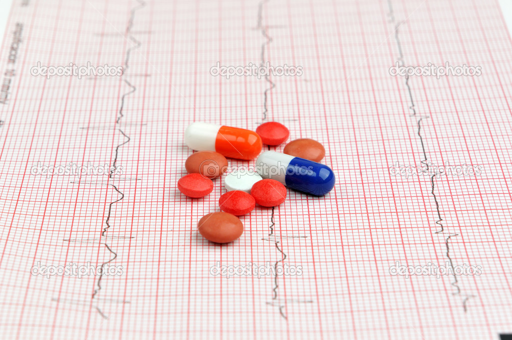 Electrocardiogram with pills and tablets above, — Stock Photo © avarand ...