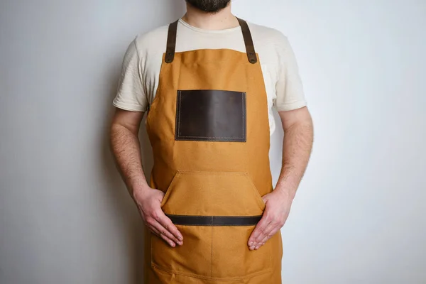 A man in a kitchen apron. Chef work in the cuisine. Cook in uniform ...