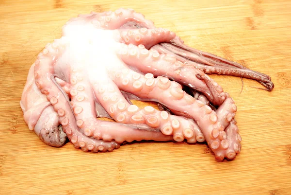 Whole Raw Octopus on a Wooden Cutting Board - Stock Image - Everypixel