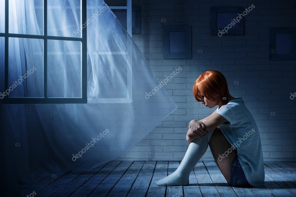 Lonely girl sits in an empty dark room — Stock Photo © idal #43967439