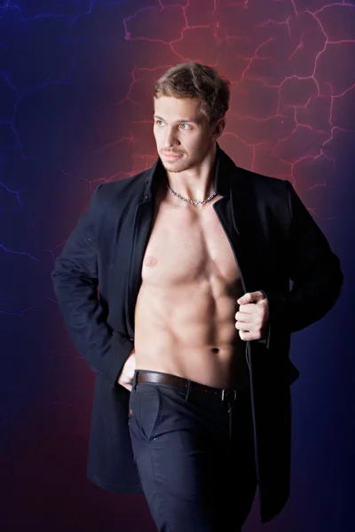 Muscular man in a coat. Stock Photo by ©kopitin 49523029