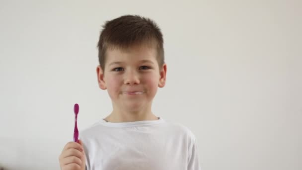 Kid boy brushing his teeth using tooth brush and oral paste, cleaning ...