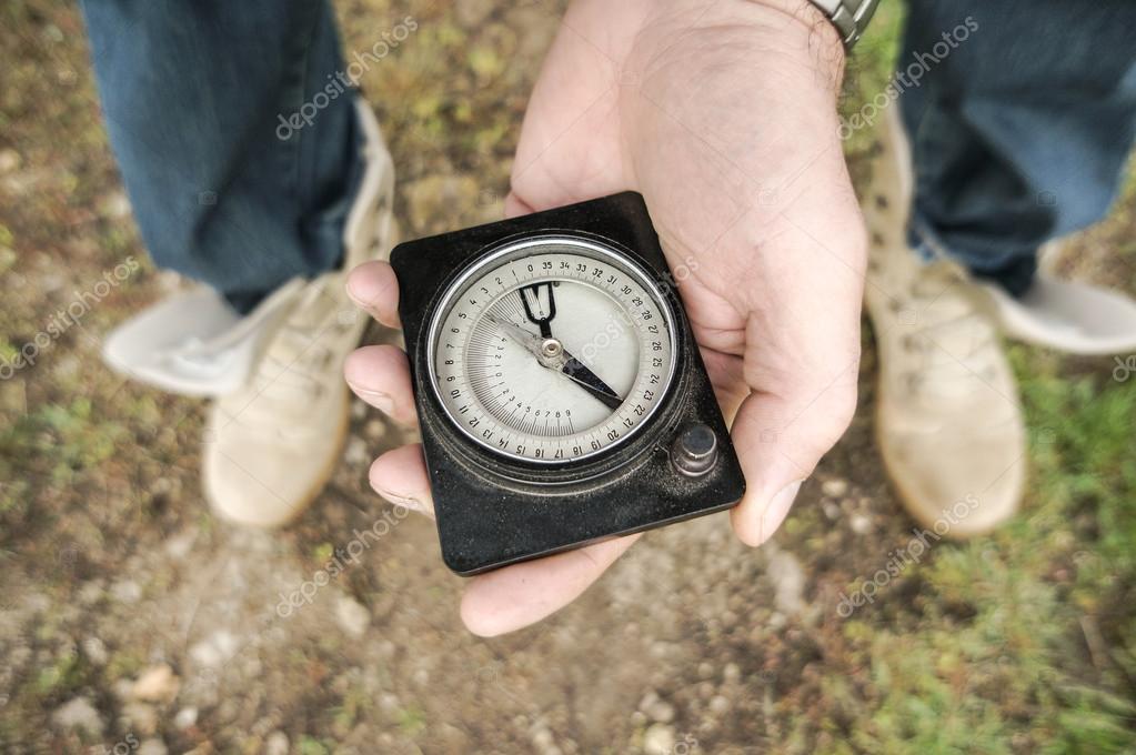 Hand holding the compass Stock Photo by ©PEPPERSMINT 46012969