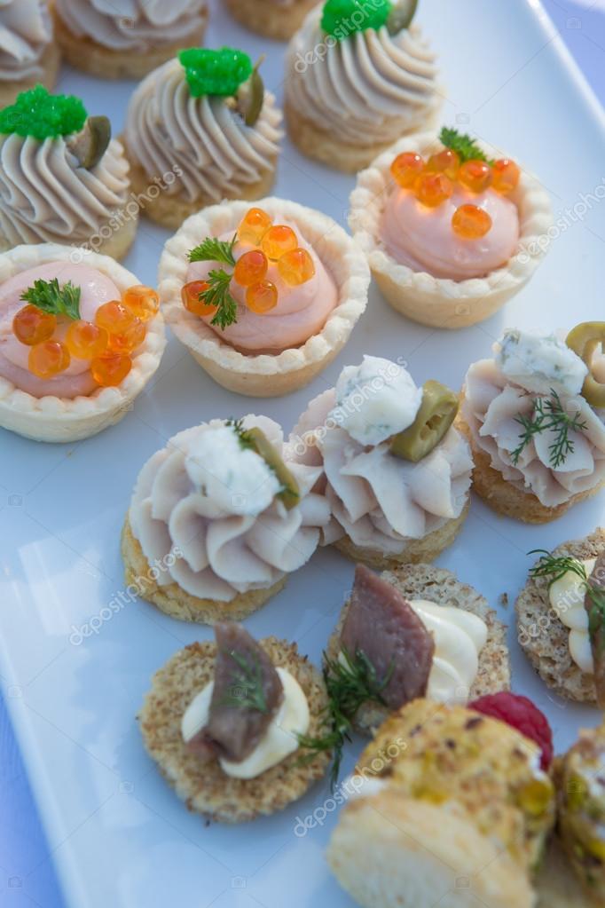 Delicious appetizer canapes on board for celebratory table — Stock ...