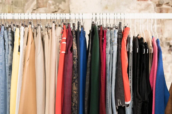 Clothes on hangers - second hand clothes store or thrift shop. Clothing ...