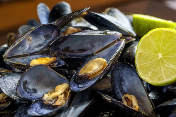 Steamed mussels in their juice with lemon. Typical mediterranean food ...