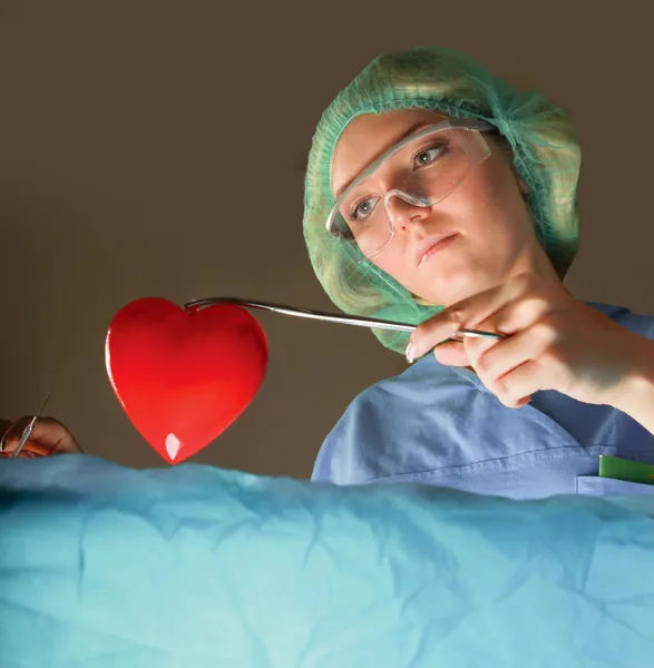 Female surgeon performing an operation on a heart patient - Stock Image ...