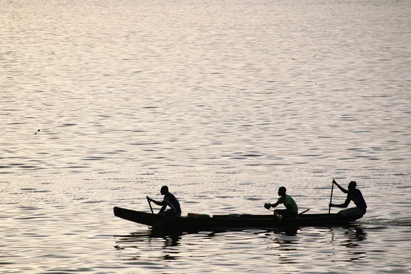 African fishermen rowing boat fishing - Stock Image - Everypixel