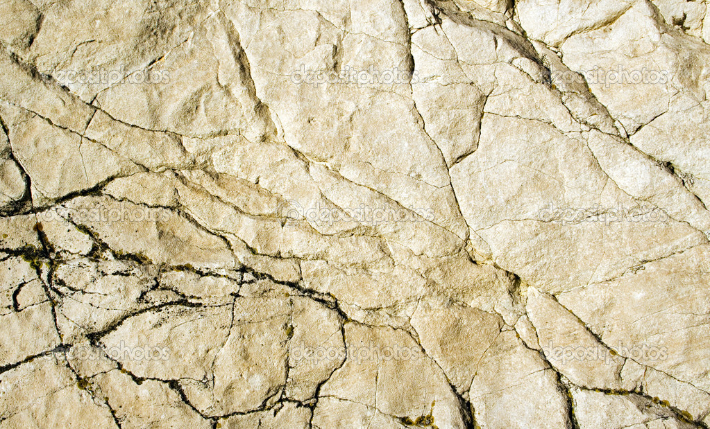 Cracked stone surface Stock Photo by ©ximinez 42332225