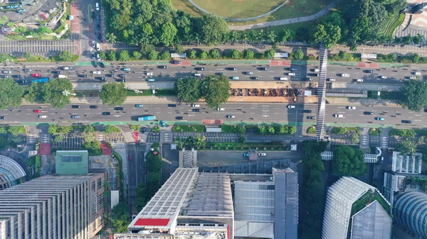 Top down view of highrise buildings with quiet traffic on the road in ...