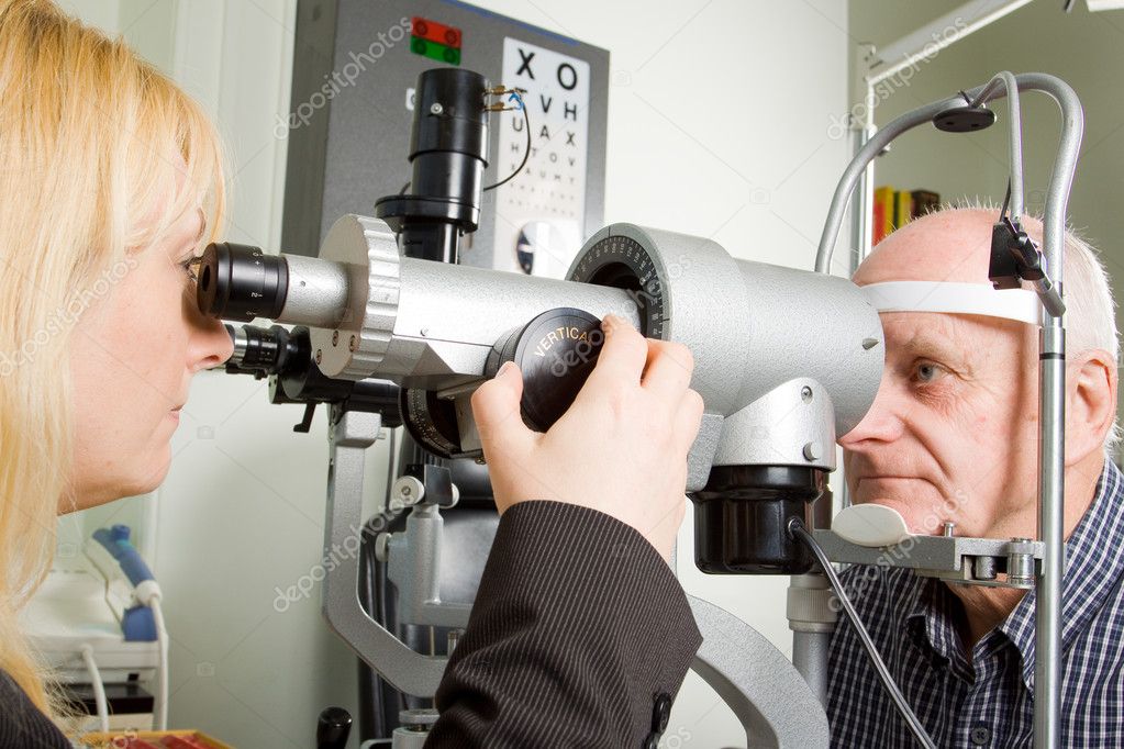 Older man having eye examination — Stock Photo © Jamstock #41868011
