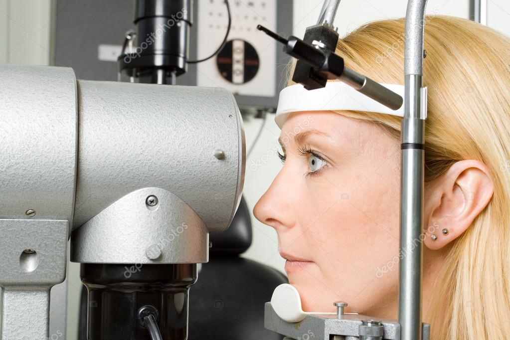 Young woman having eye test — Stock Photo © Jamstock #41873775