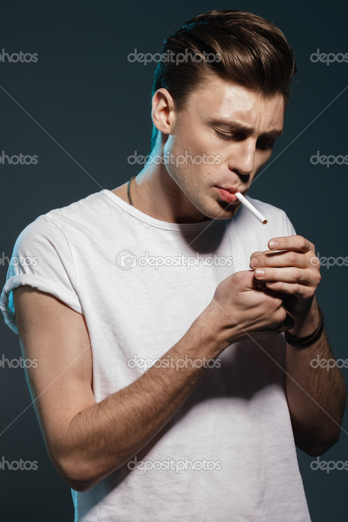 Handsome young man smoking cigarette Stock Photo by ©MrCat.com.ua 48695357