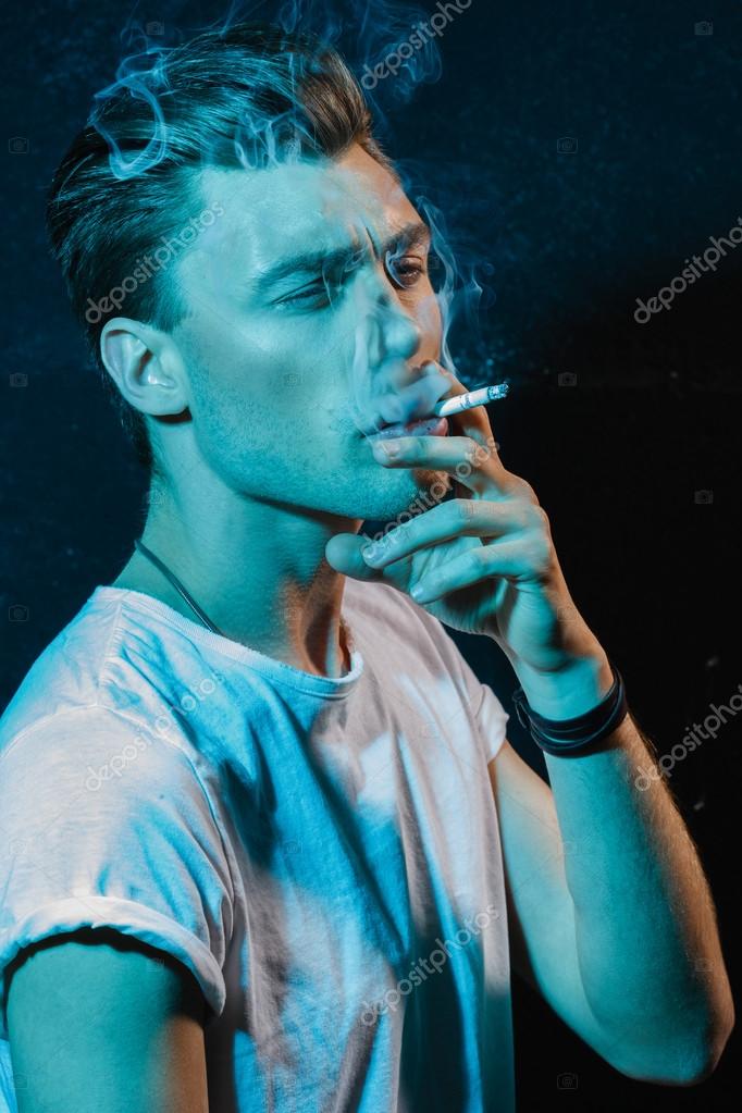 Handsome young man smoking cigarette Stock Photo by ©MrCat.com.ua 49586809