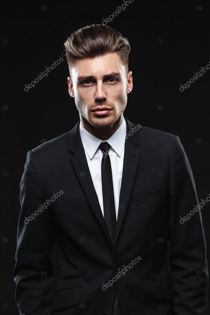 Handsome young man in suit on dark background Stock Photo by ©MrCat.com ...