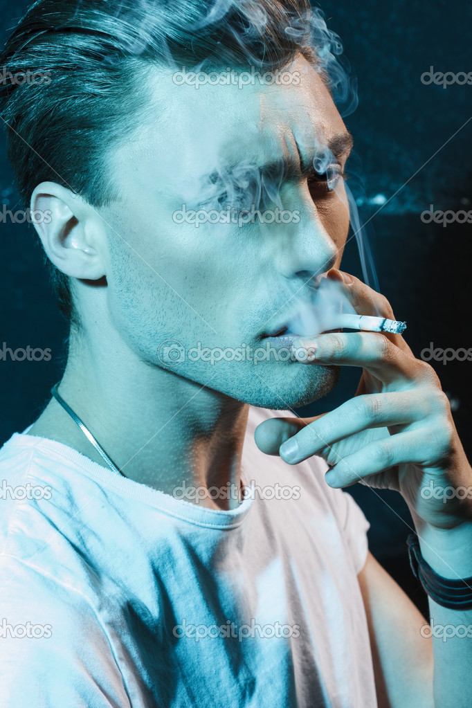Handsome young man smoking cigarette — Stock Photo © MrCat.com.ua #50935439