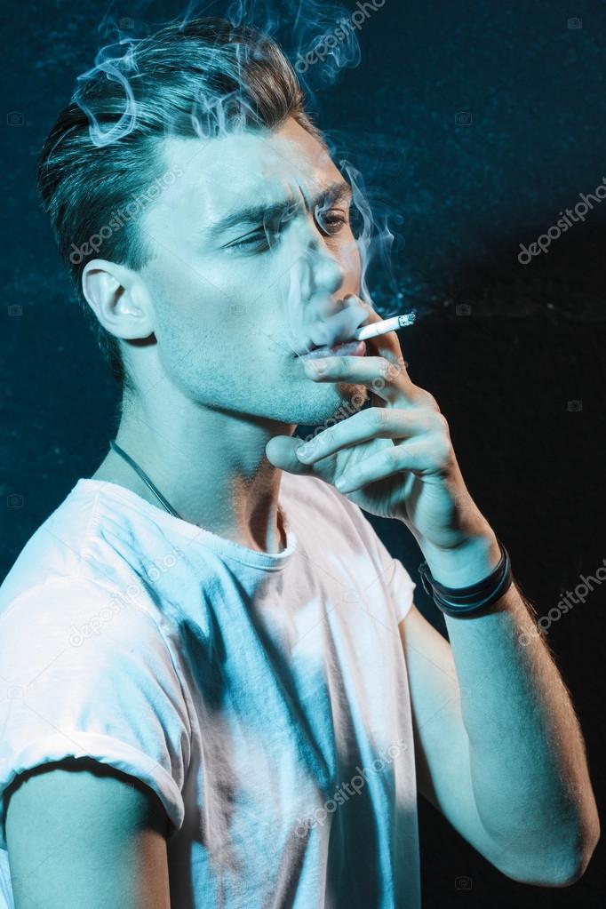 Handsome young man smoking cigarette — Stock Photo © MrCat.com.ua #51012203