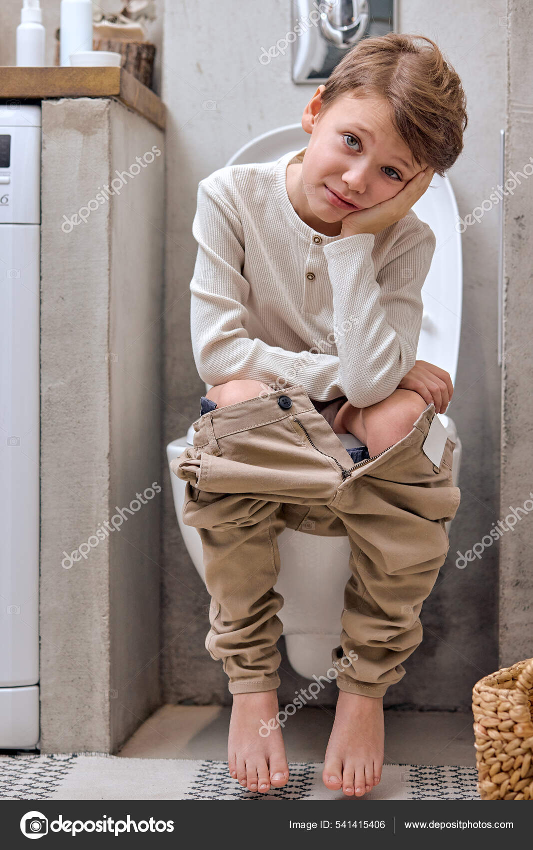 Child boy is sitting on toilet with suffering from constipation or ...