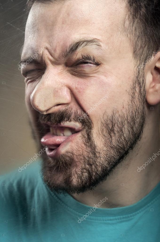 Young man smashing his face against the scratched glass — Stock Photo ...