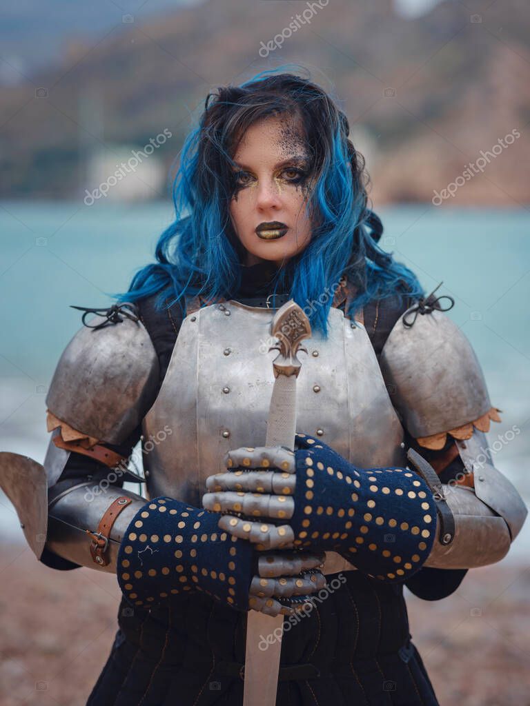 Medieval knight woman in armor prays, blessing before the battle. The ...