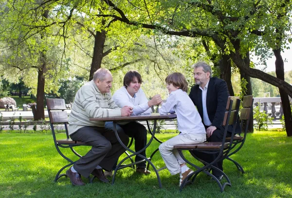 Four generations of men and a baby girl in a park ⬇ Stock Photo, Image ...