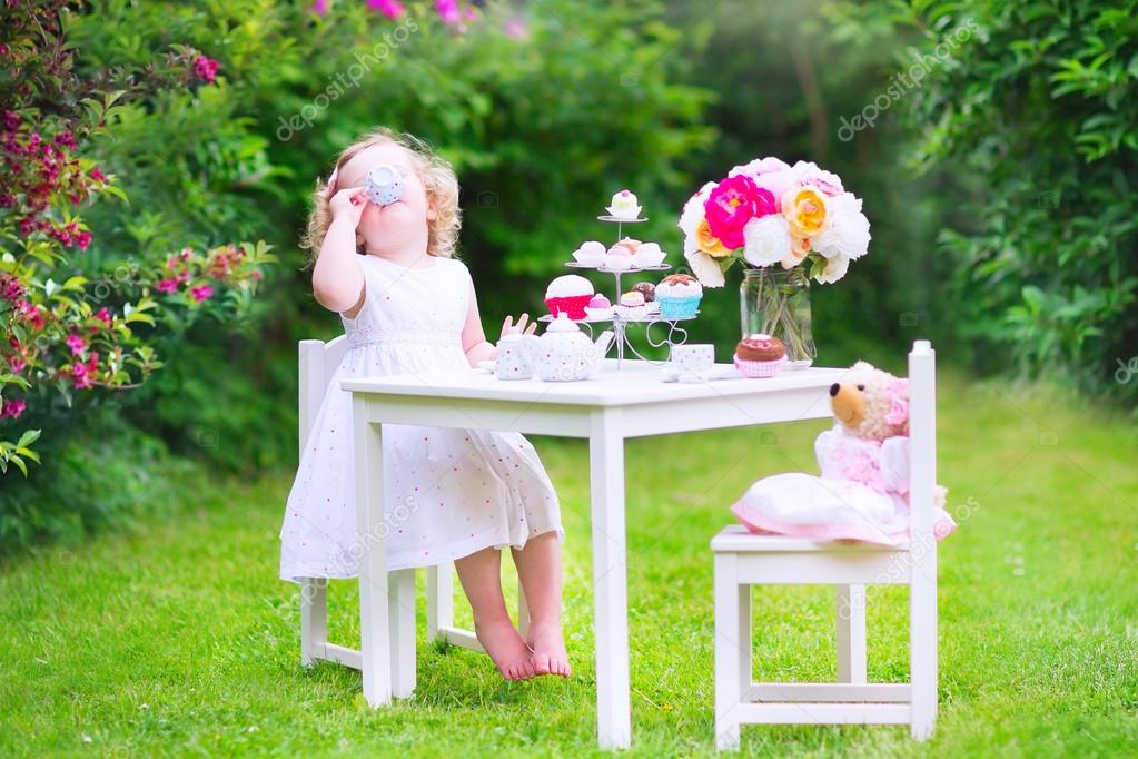 Toddler girl playing tea party with a doll Stock Photo by ©FamVeldman ...