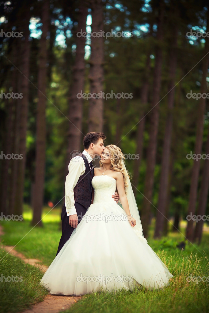 Young Bride and groom posing in park — Stock Photo © serbogachuk5 #42905501