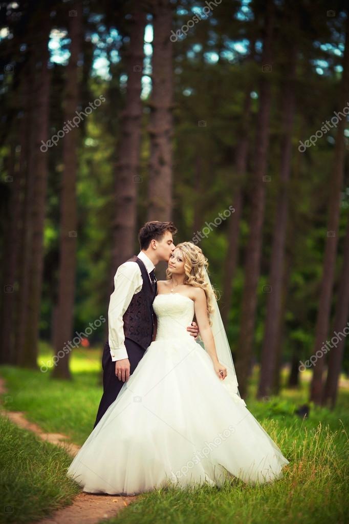 Young Bride and groom posing in park — Stock Photo © serbogachuk5 #42929003