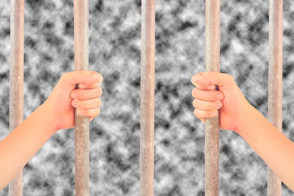 Hand holding grip on the bars of the cage - Stock Image - Everypixel