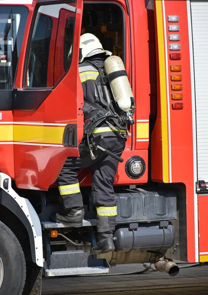 Firefighter at work in the city street - Stock Image - Everypixel