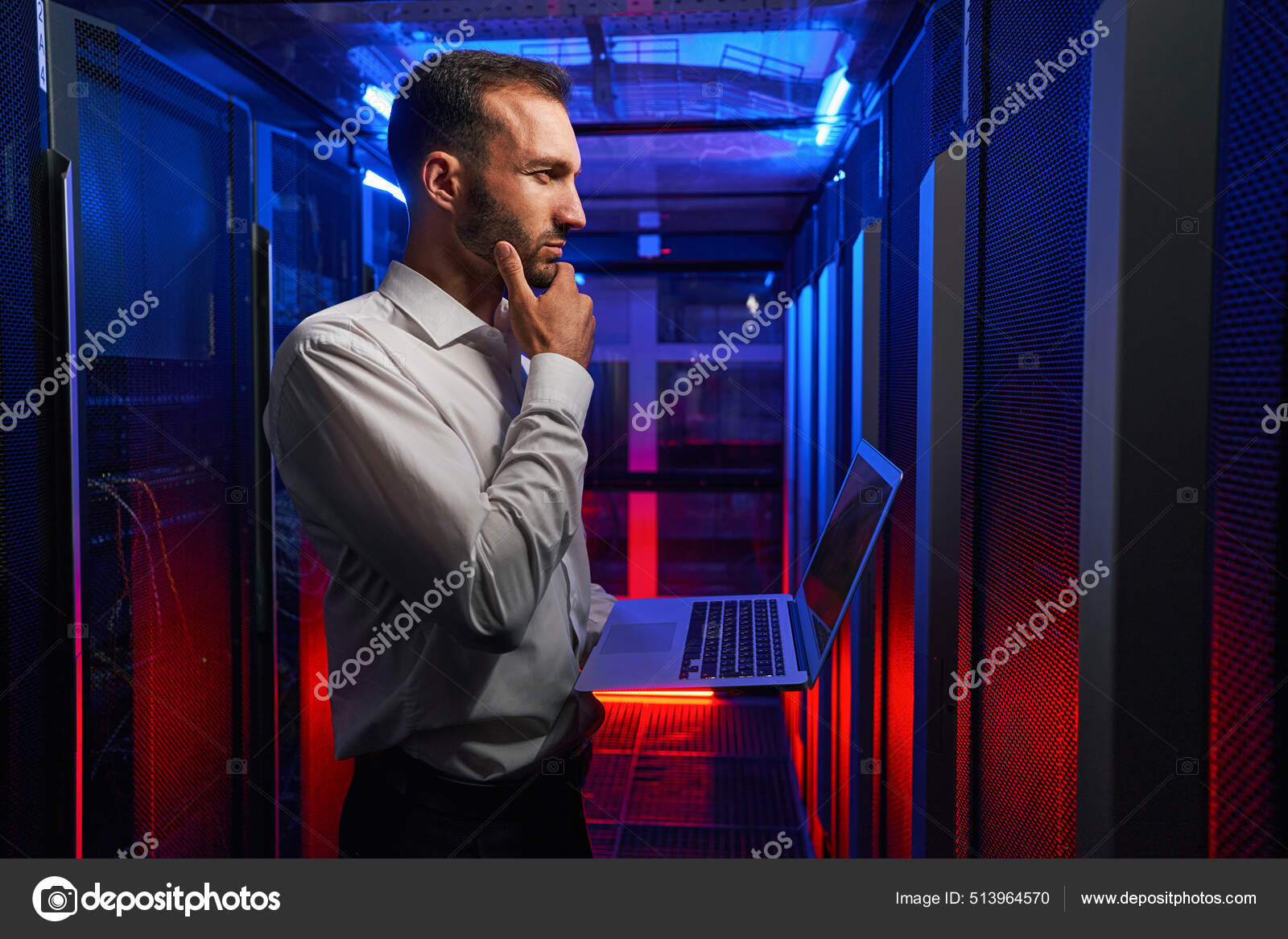 Bearded concentrated network engineer examining work of supercomputer ...