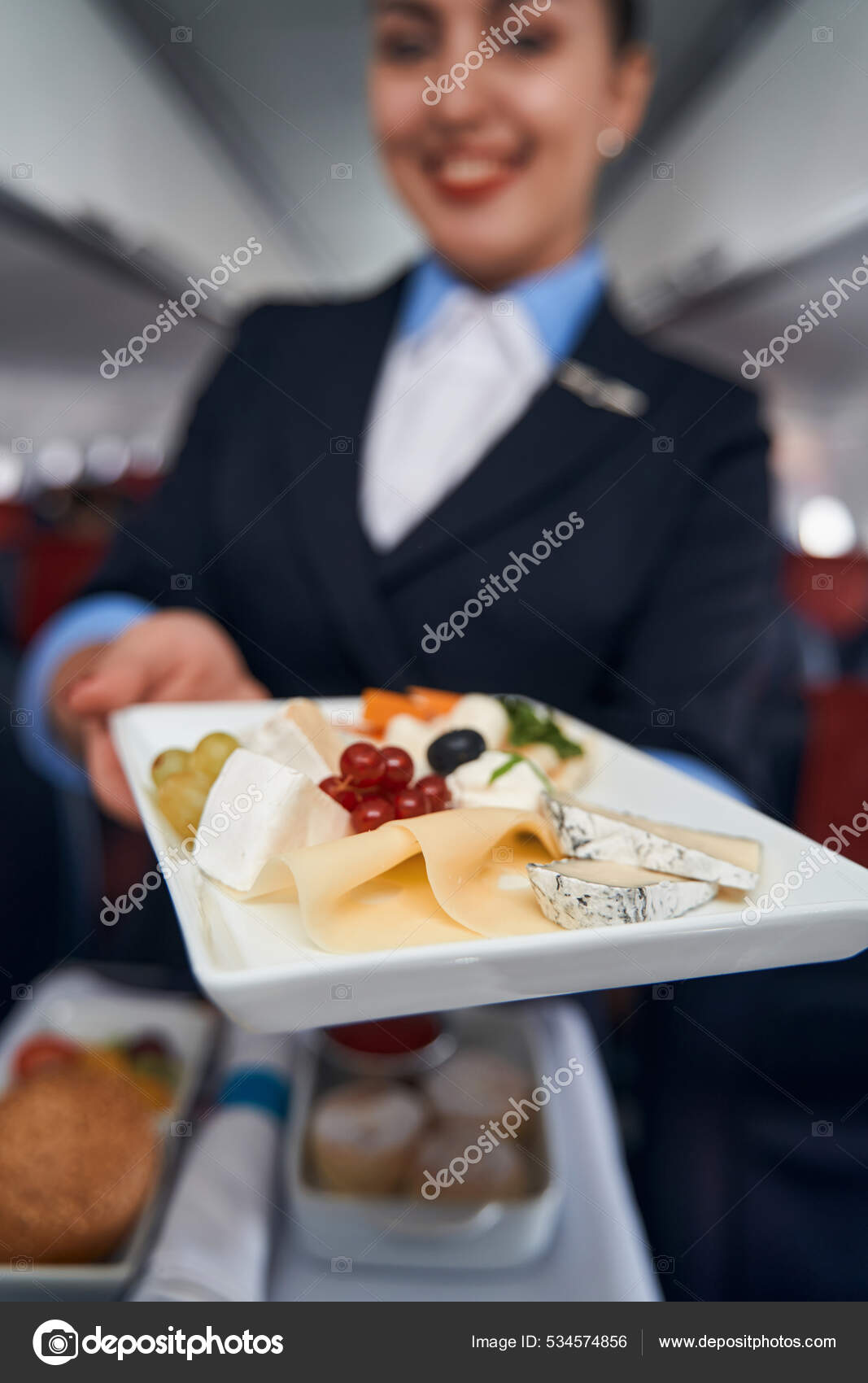 Flight attendant handing out plate with breakfast Stock Photo by ...