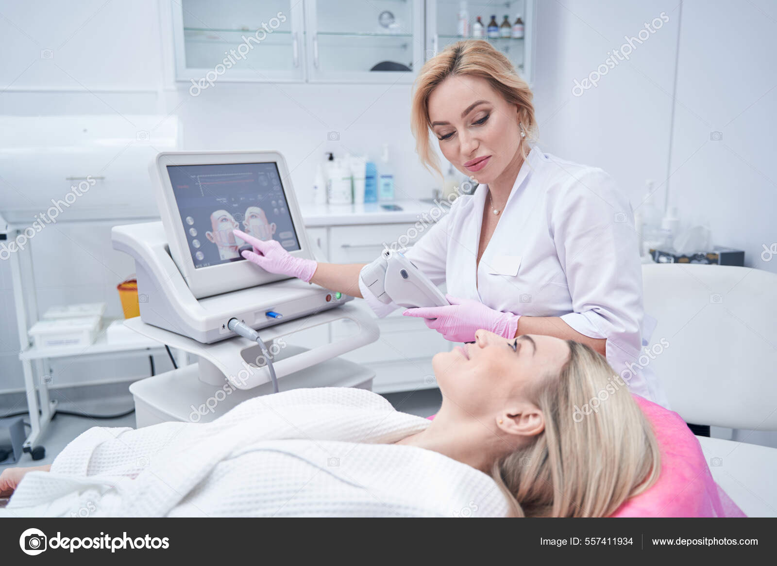 Dermatologist adjusting treatment setting for patient before cosmetic ...
