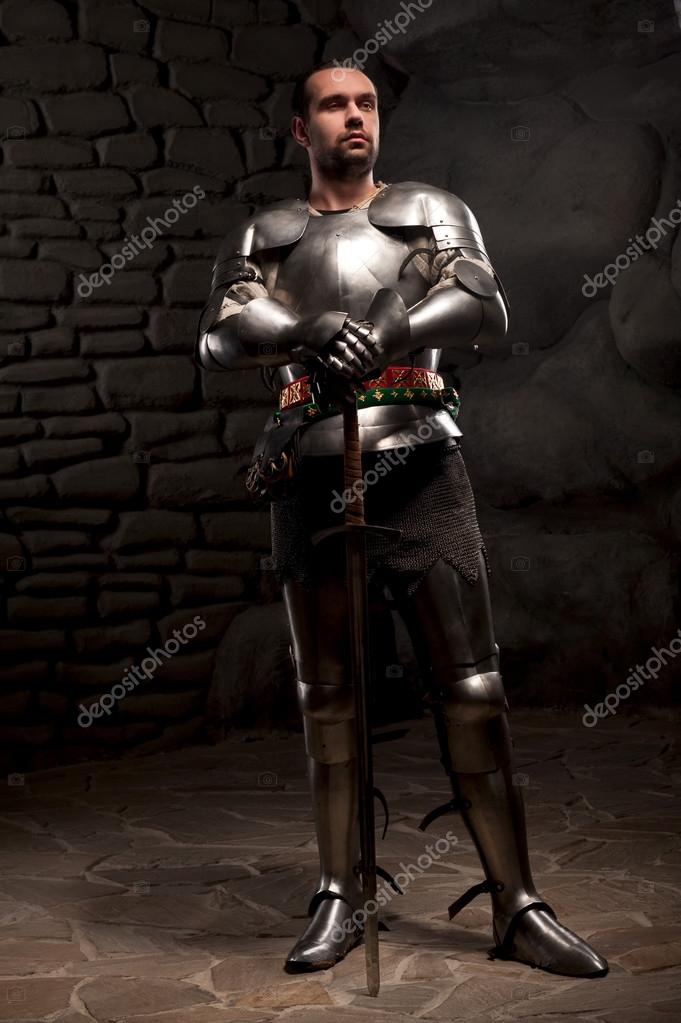 Medieval Knight posing with sword Stock Photo by ©Dmyrto_Z 49116767