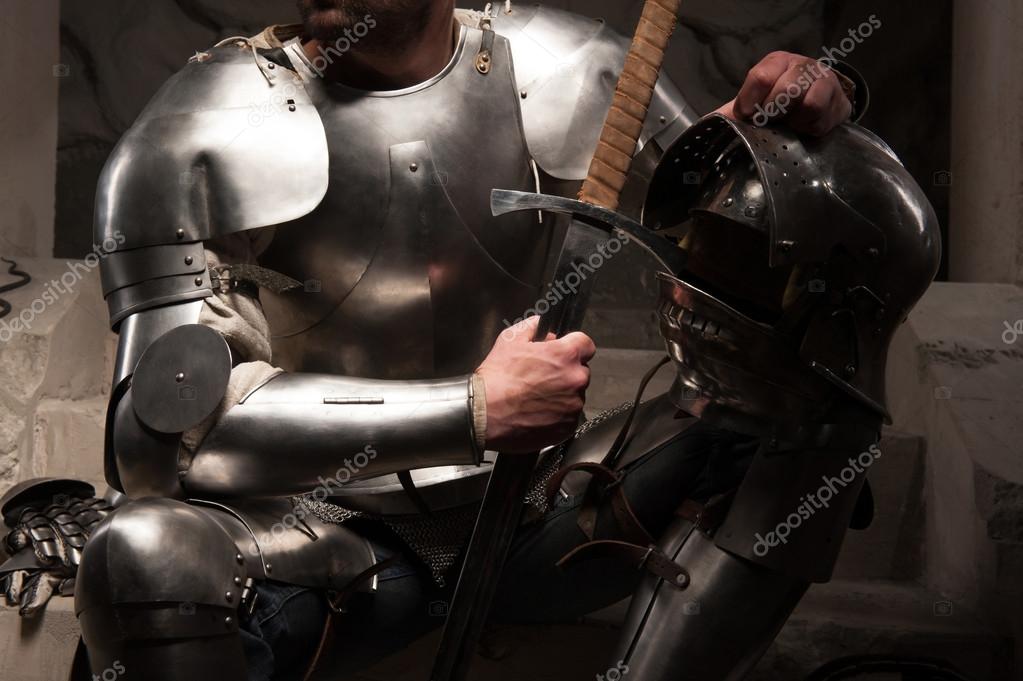 Knight in armor with helmet and sword Stock Photo by ©Dmyrto_Z 49117089
