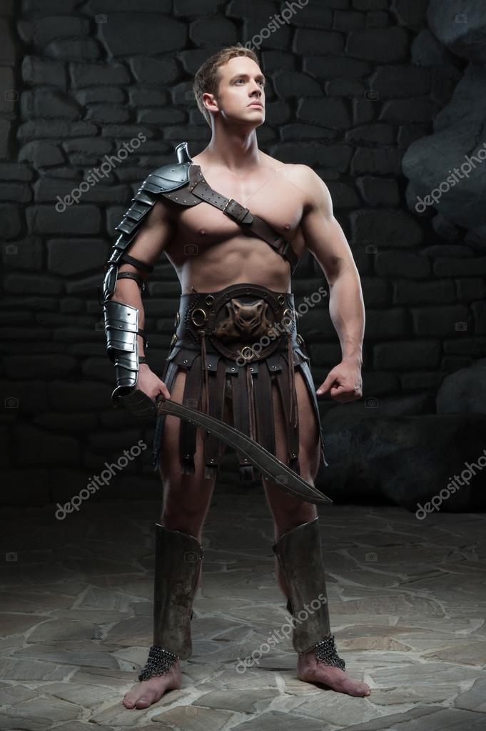 Gladiator with sword posing Stock Photo by ©Dmyrto_Z 50320271